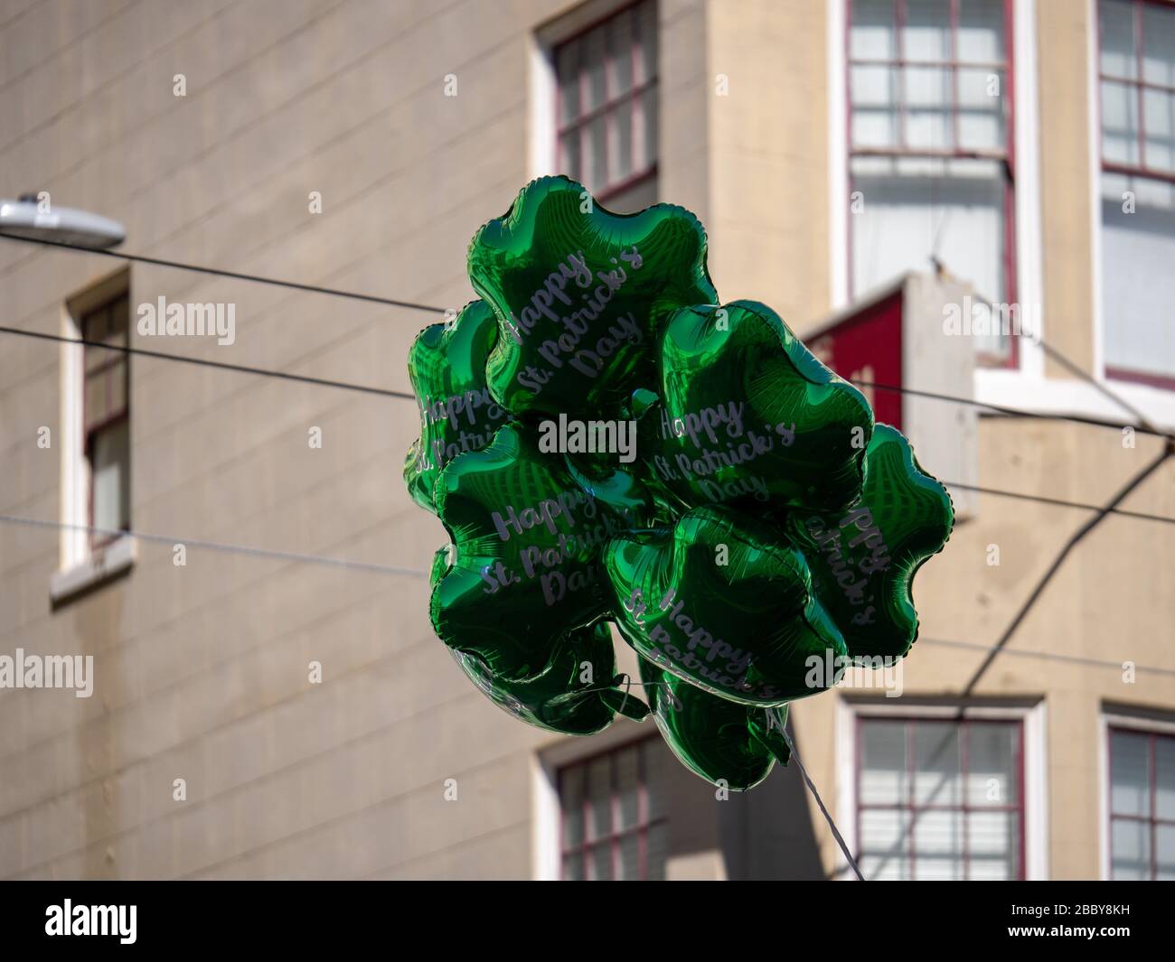 Festive happy St Patrick s Day green shamrock balloons floating in ...