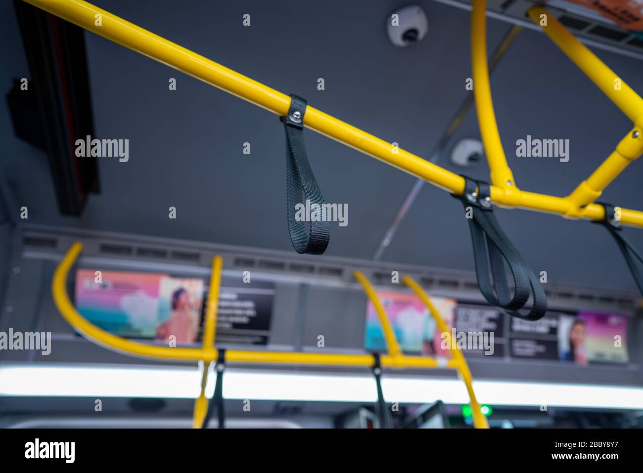 Suspended safety rail wrist straps on public transportation bus Stock ...