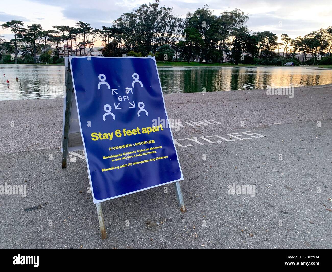 Coronavirus COVID-19 social distancing signboard warning people to stay ...