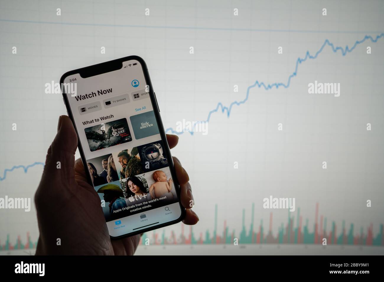 Apple TV app on phone with white financial stock chart with price ...