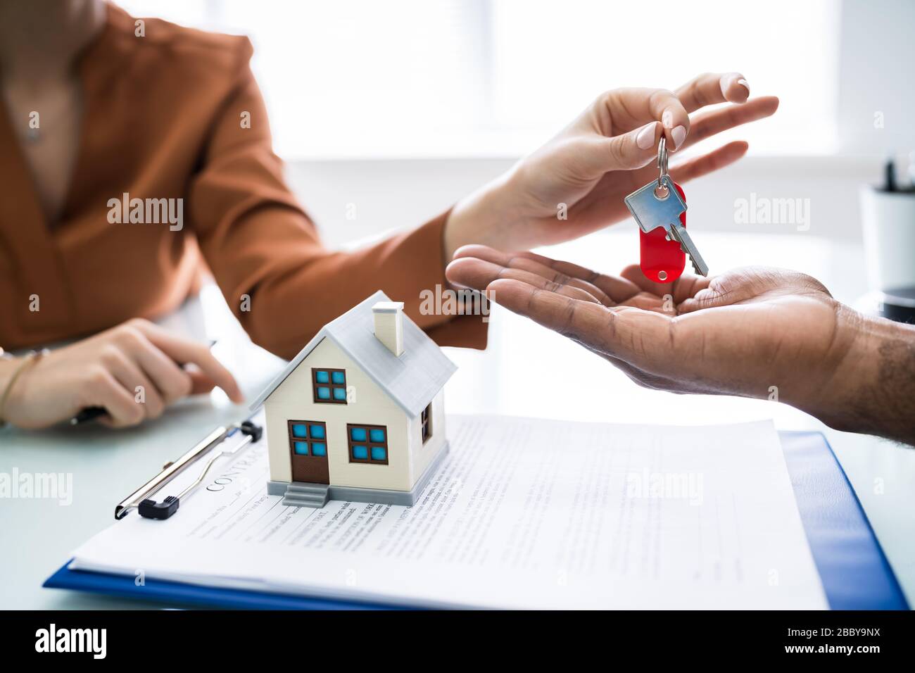 Realtor Giving House Keys To Client After Signing Contract Stock Photo ...