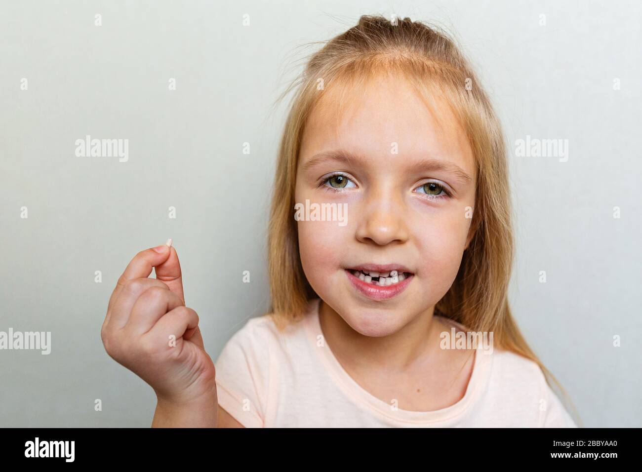 Kid showing the first milk tooth. Change teeth concept. Cute little ...