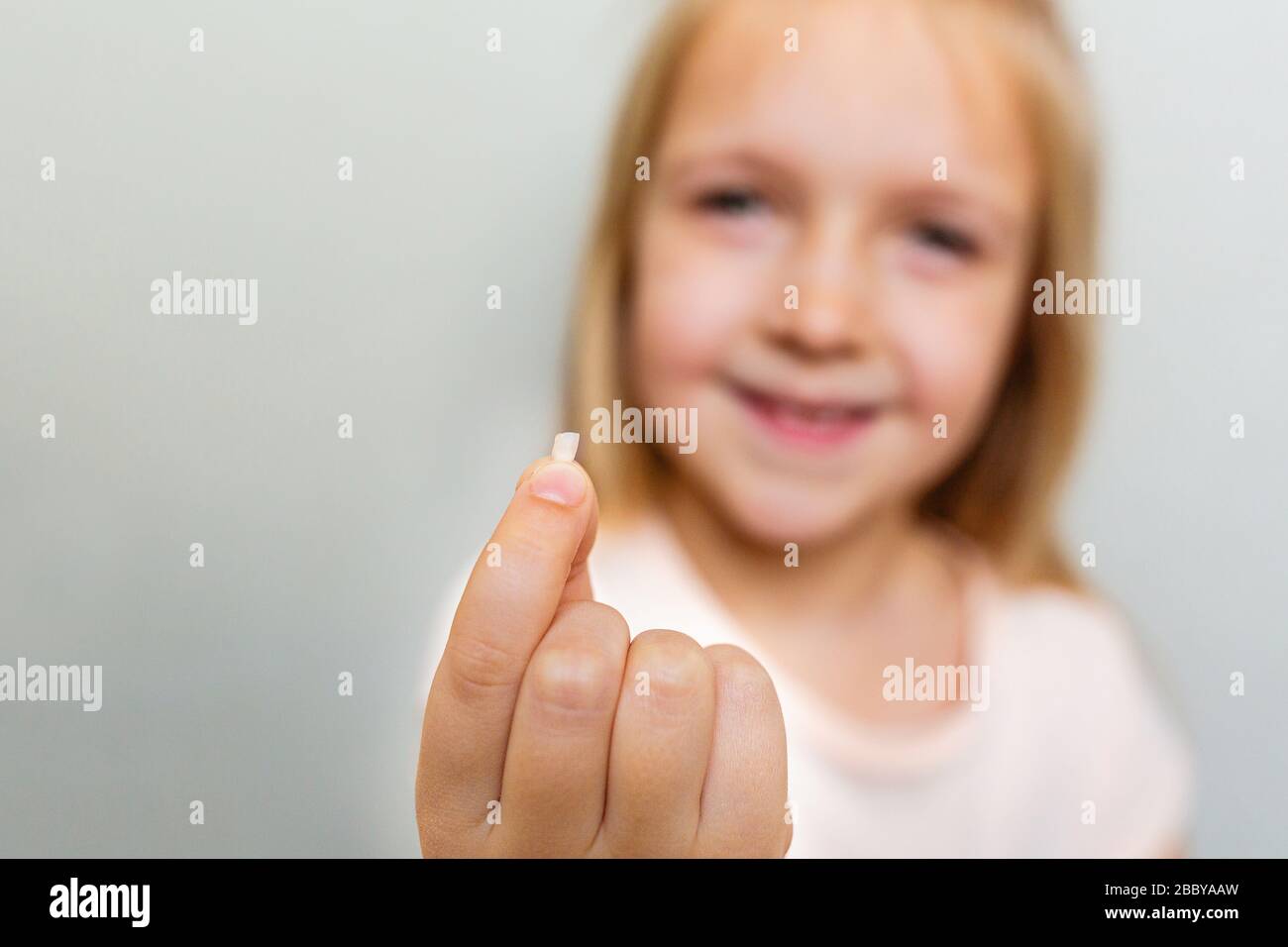 Smiling blonde girl missing tooth hi-res stock photography and images - Alamy