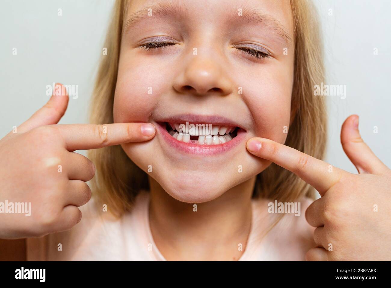Kid showing the first milk tooth. Change teeth concept. Cute little ...
