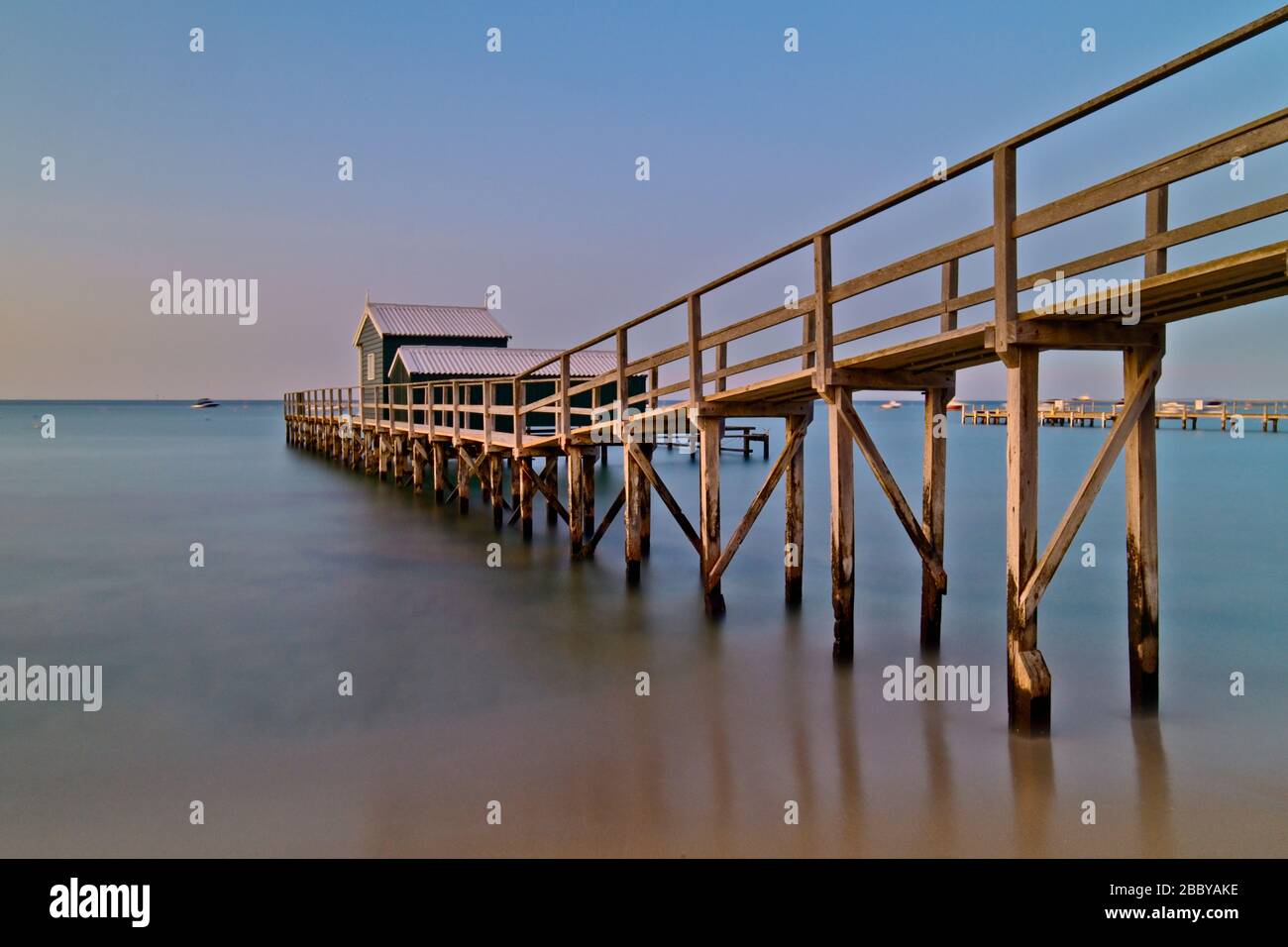 Wooden jetty at Shelly Beach, Portsea, in smooth aqua water Stock Photo ...