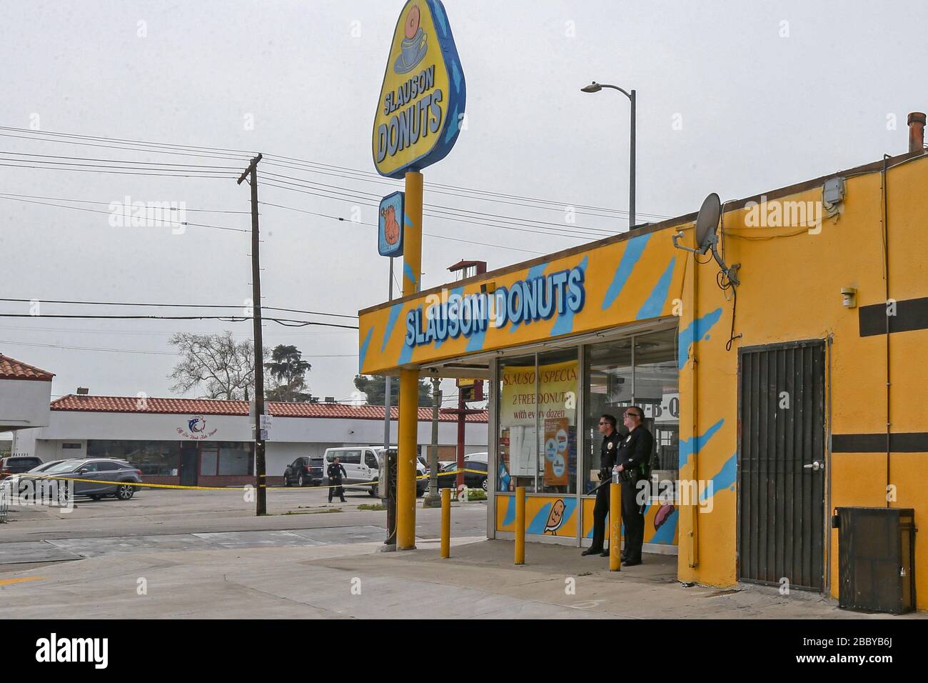 LAPD officers stand in front of Slauson Donuts at 3420 W Slauson Ave F ...
