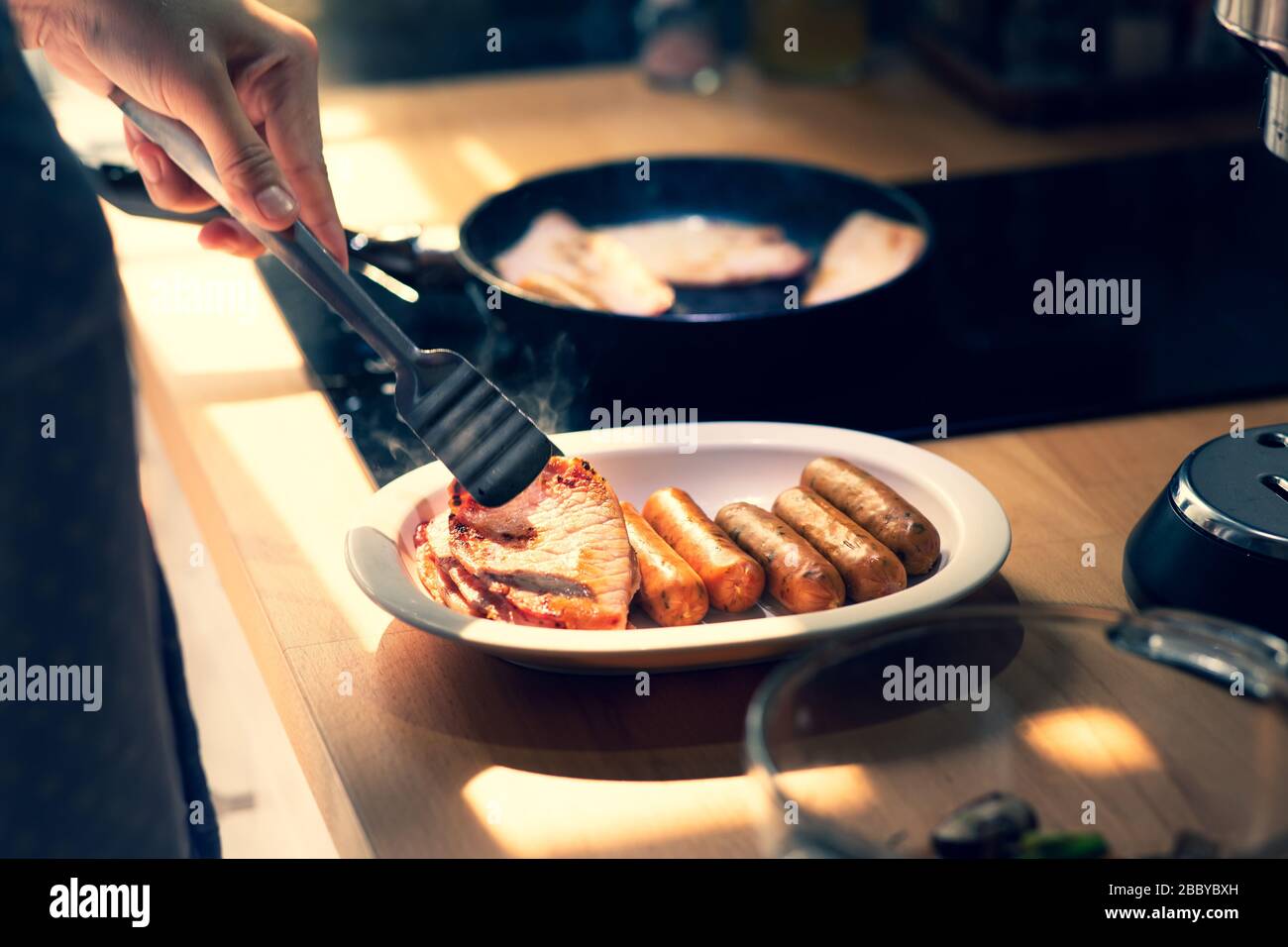 Selective focus of female cooking breakfast on kitchen counter bar ...