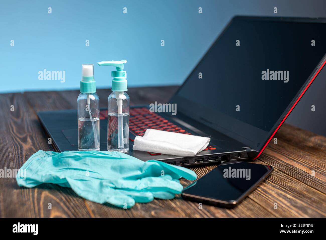 Sterile gloves and sanitizer next to the laptop. Treating your ...
