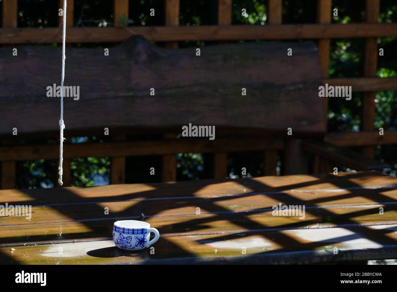 teacup on a wet table in a garden gazebo Stock Photo - Alamy