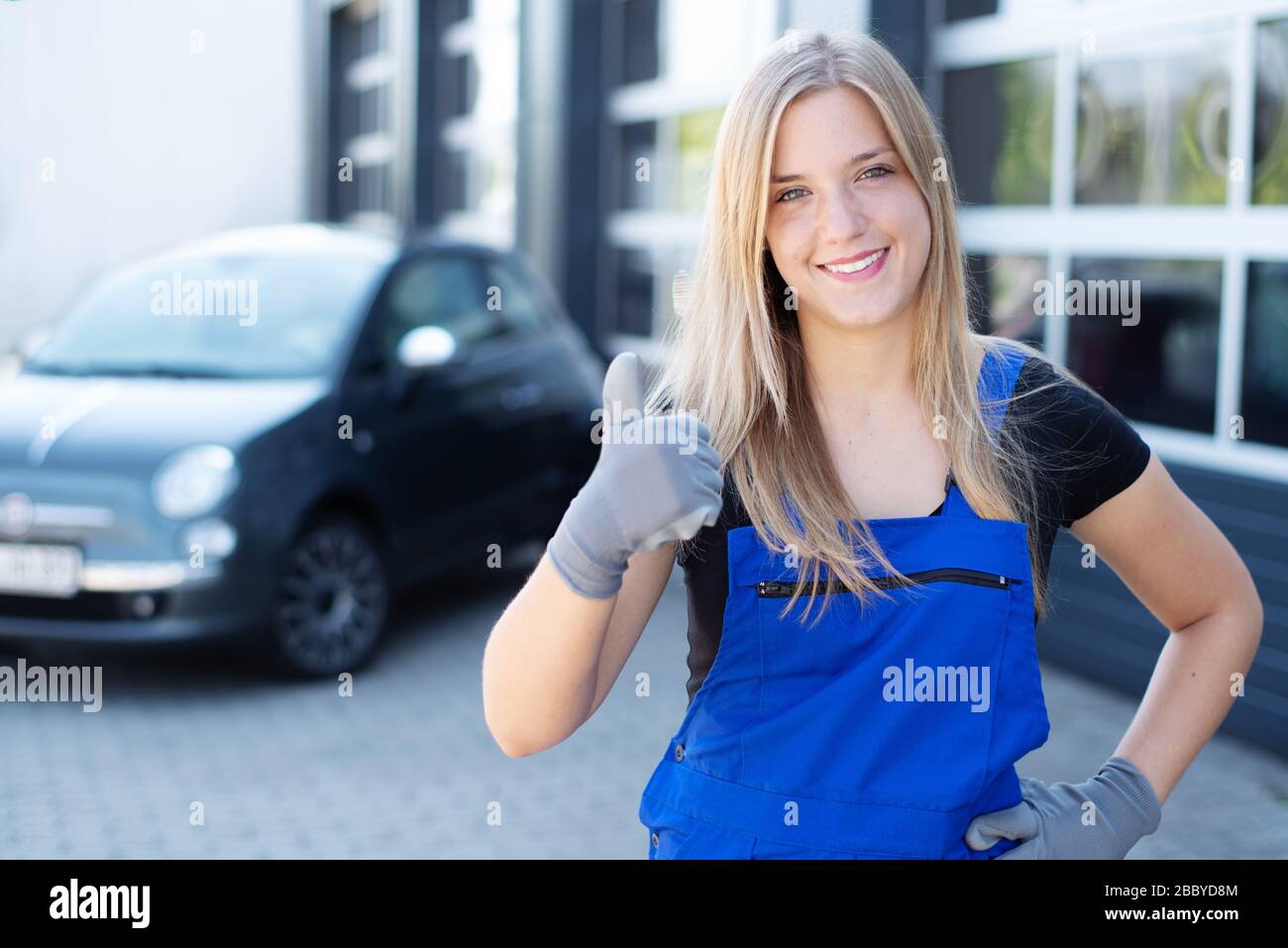 Young woman at an auto repair shop Stock Photo - Alamy