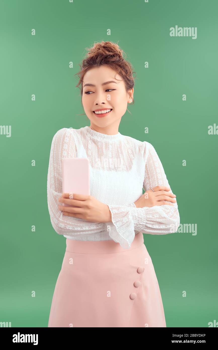 Beautiful attractive Asian woman standing over green background Stock ...