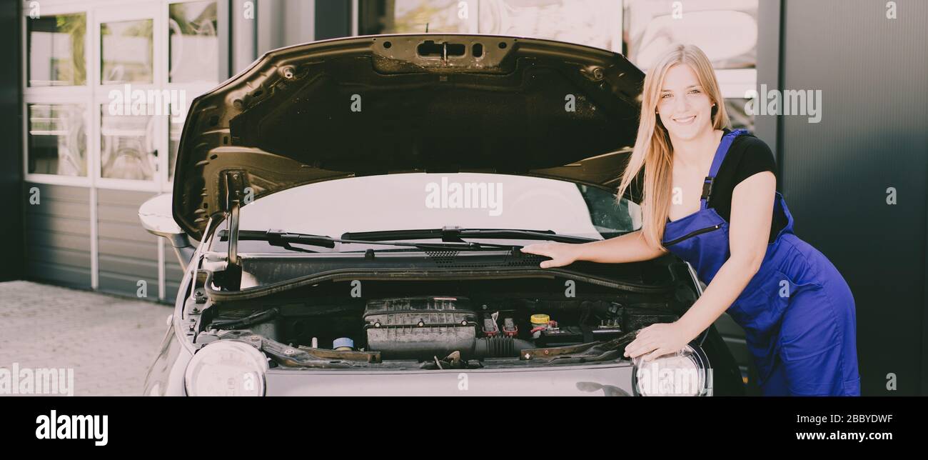 Young woman at an auto repair shop Stock Photo - Alamy