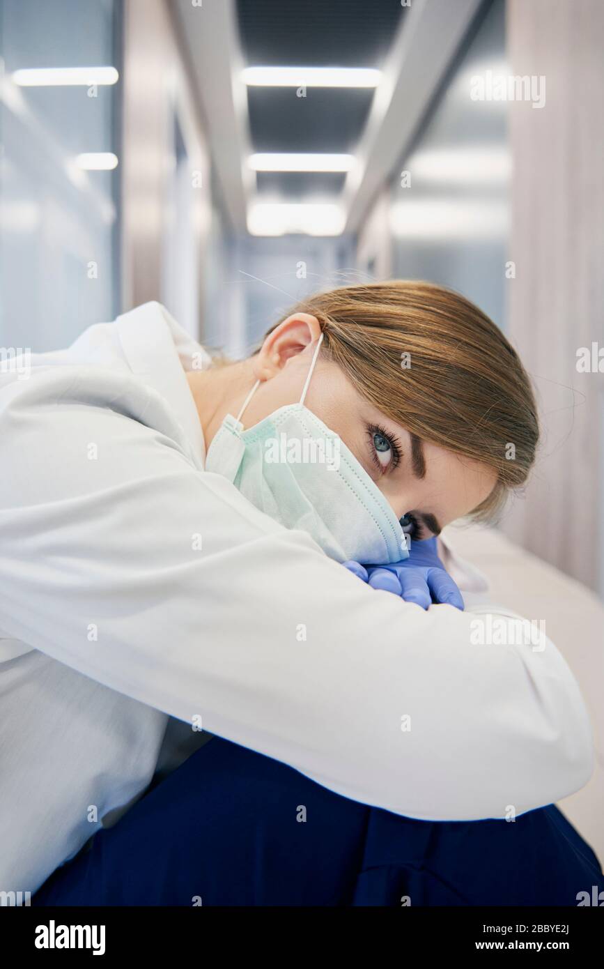 Tired doctor at the corridor Stock Photo - Alamy