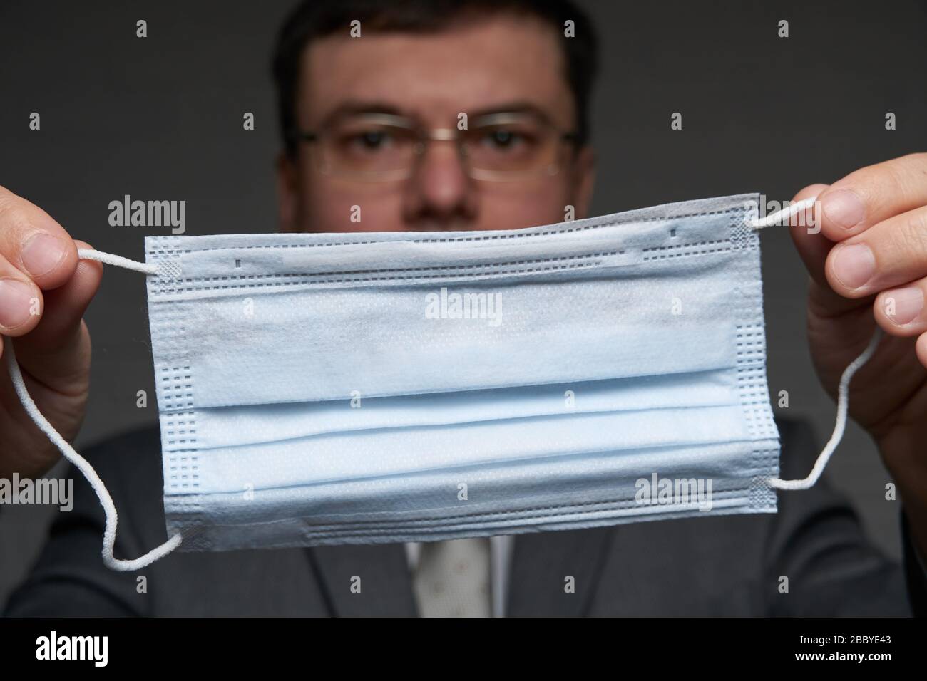 a man demonstrates a protective face mask for antivirus individual ...