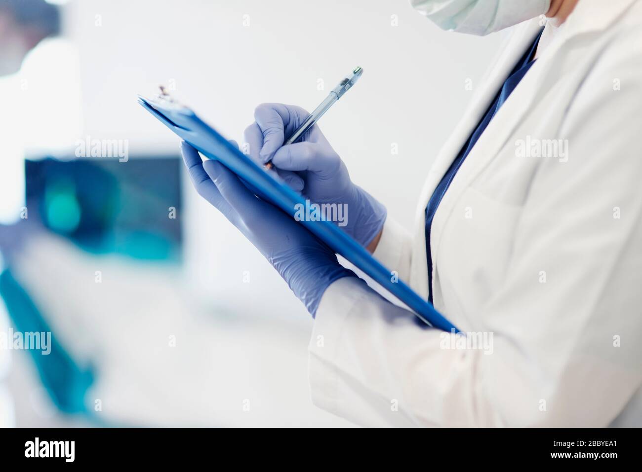 Doctor checking notes hi-res stock photography and images - Alamy