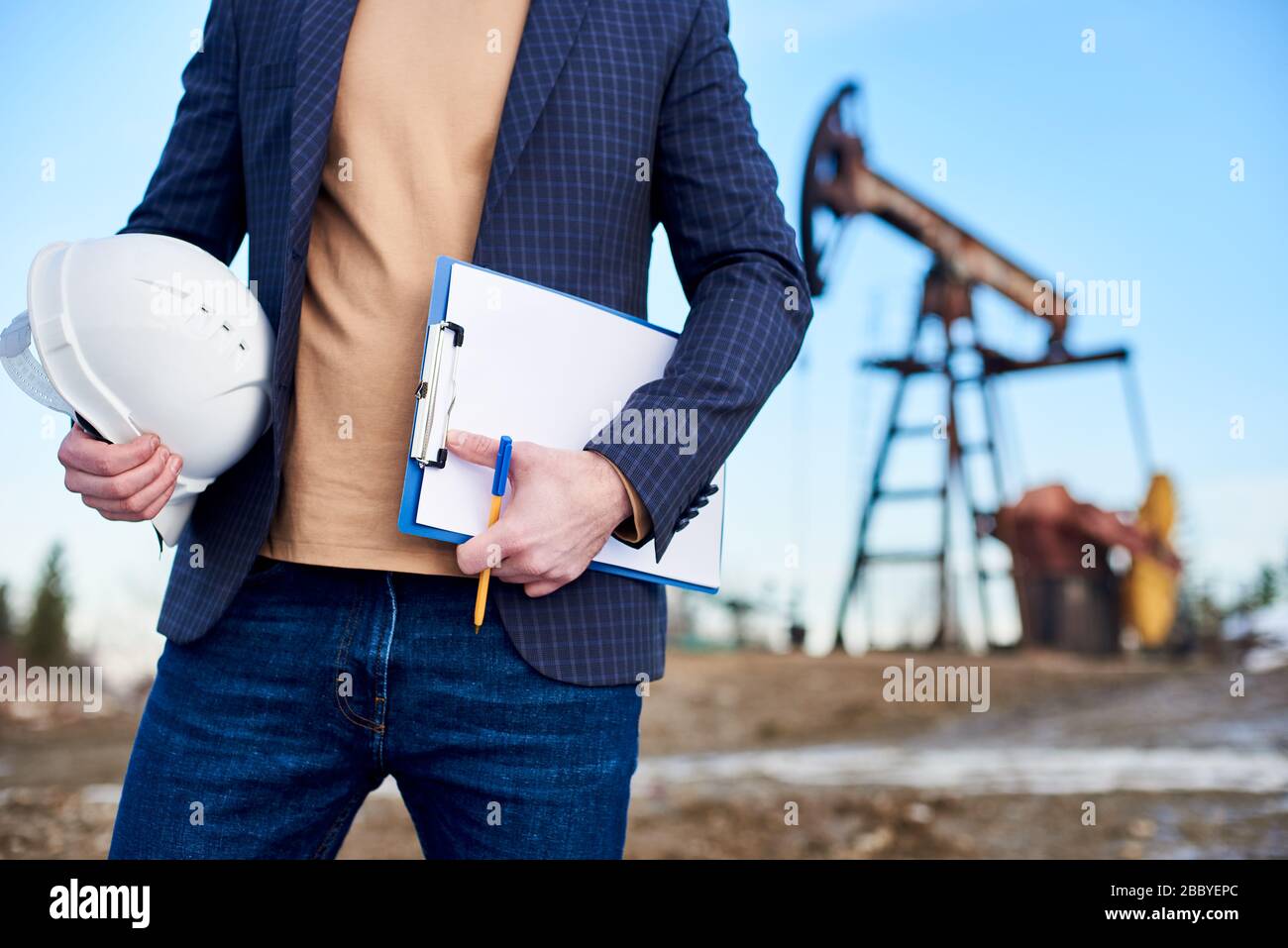 Engineer in suit holding helmet hi-res stock photography and images - Alamy