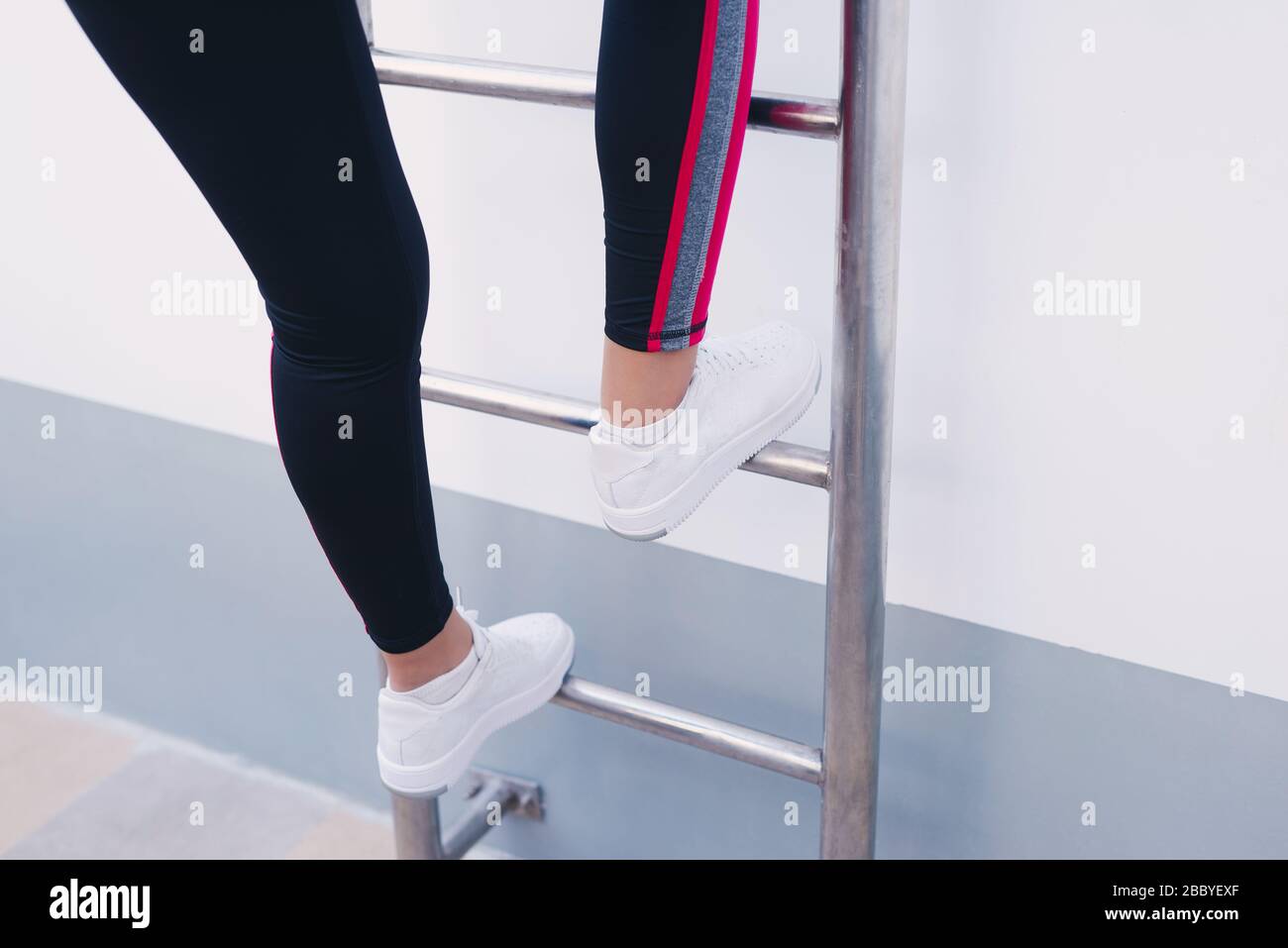 Photo of young girl climbing on ladder step by step Stock Photo - Alamy