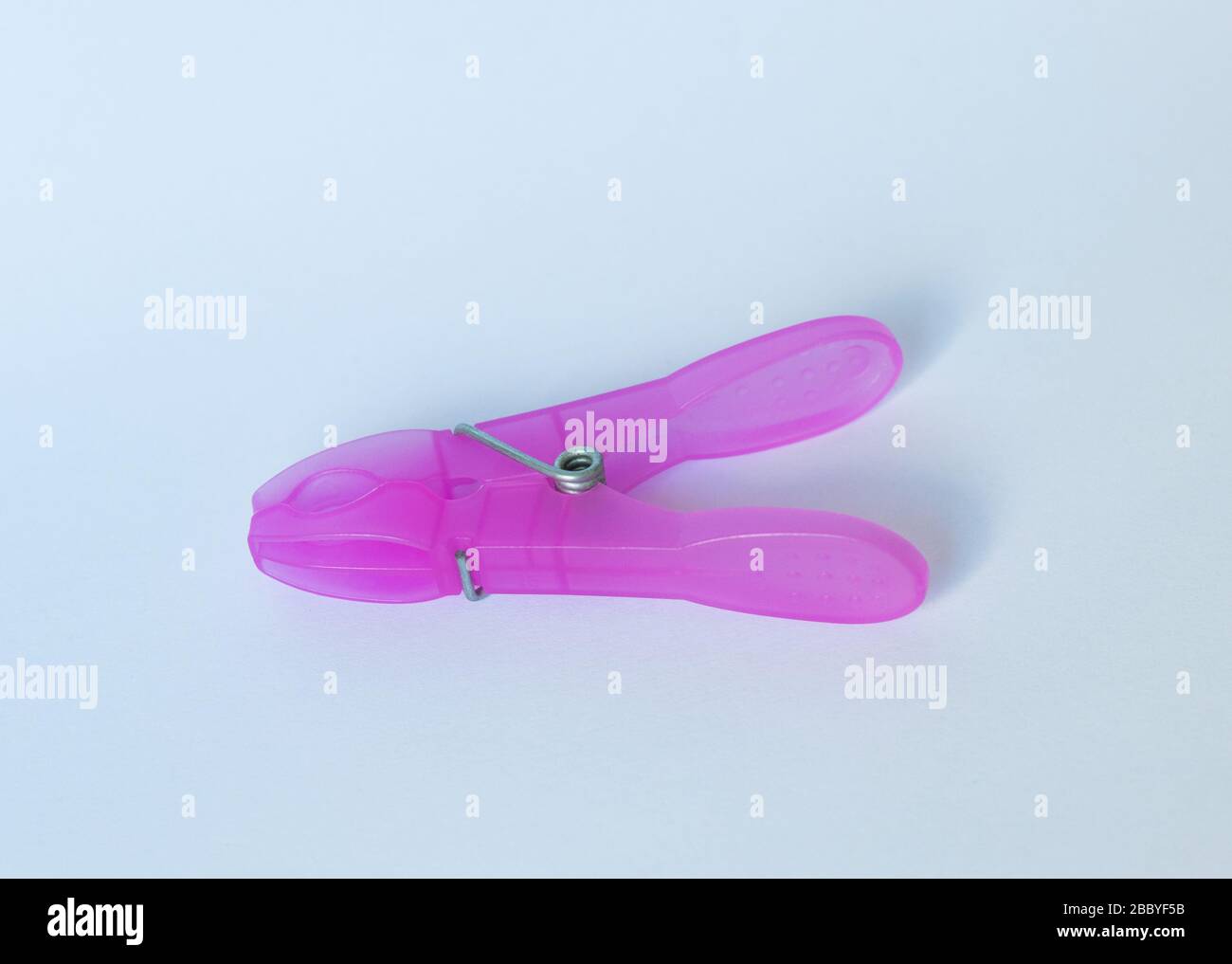 Plastic pink clothespin on a white isolated background Stock Photo - Alamy