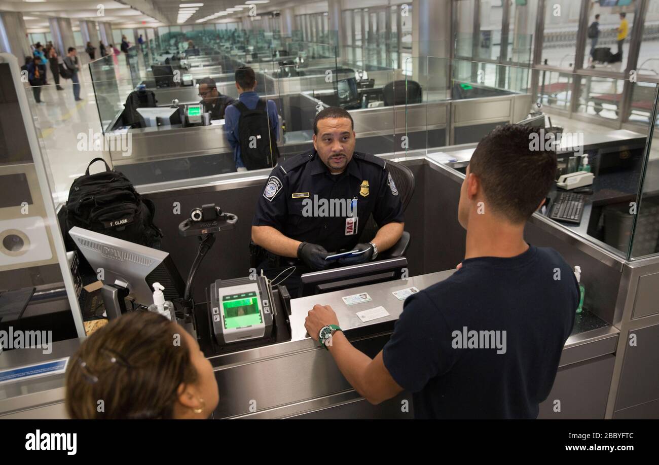 U.S. Customs and Border Protection officers screen international ...