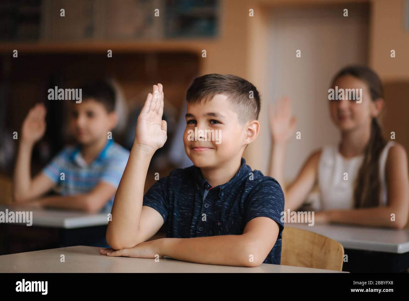 Happy little children in elementary school. Boys and girls study ...