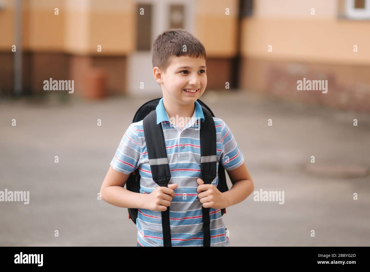 Cute little boy with backpack go home after school class Stock Photo ...