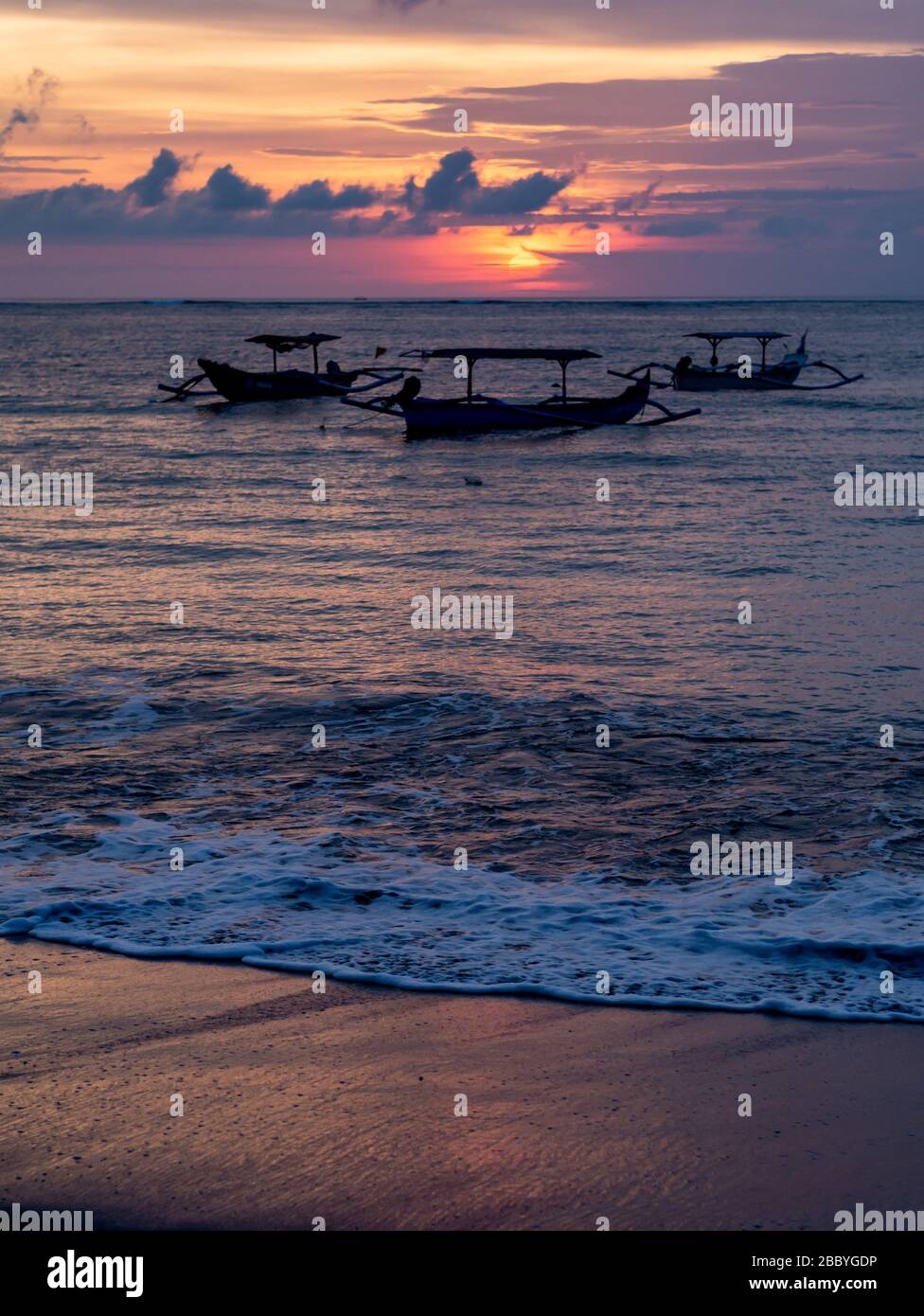 Sunset at the beach in Kuta Bali Stock Photo - Alamy