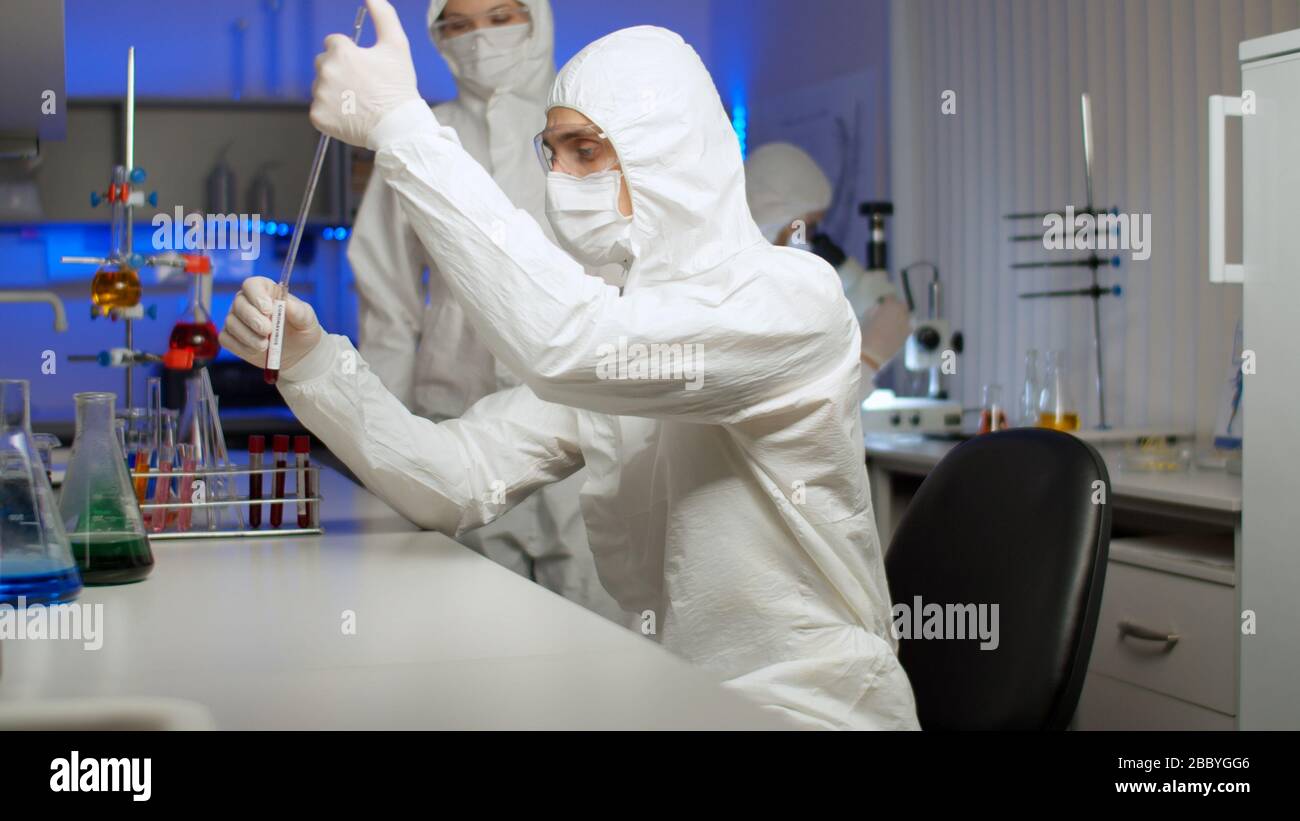 Biologist examining a virus sample in laboratory Stock Photo - Alamy