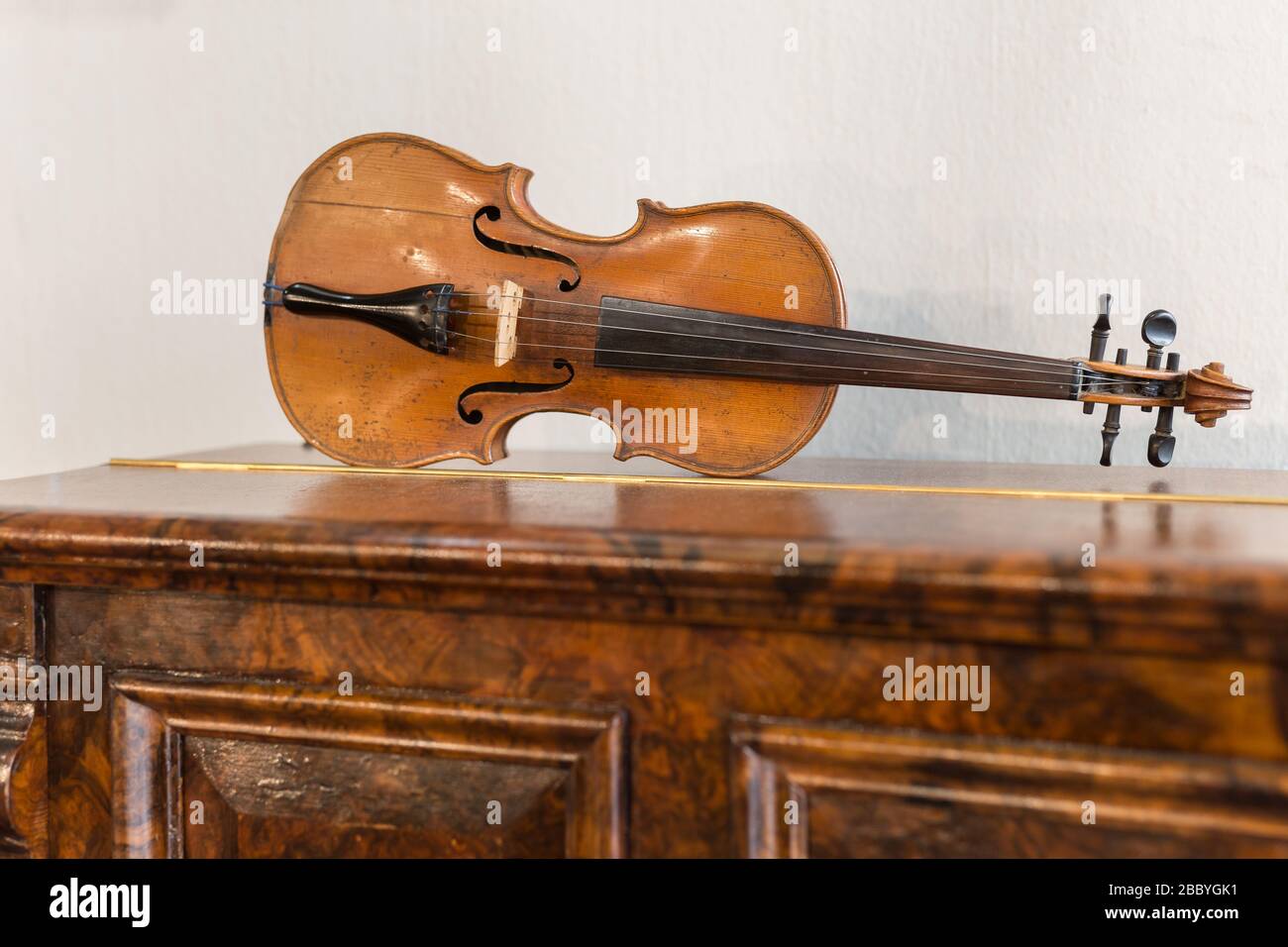 Ancient Violin Resting on an Antique Wooden Furniture Stock Photo - Alamy