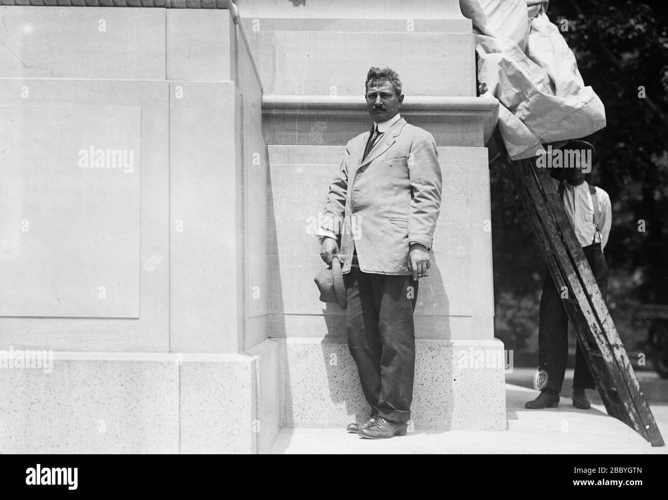 Sculptor Attilio Piccirilli standing next to the memorial he designed ...