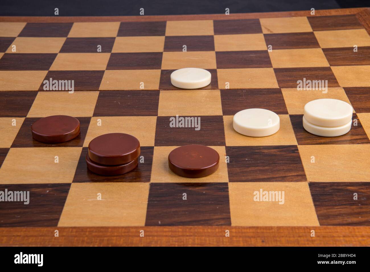 Checkers game with figures black and white Stock Photo - Alamy