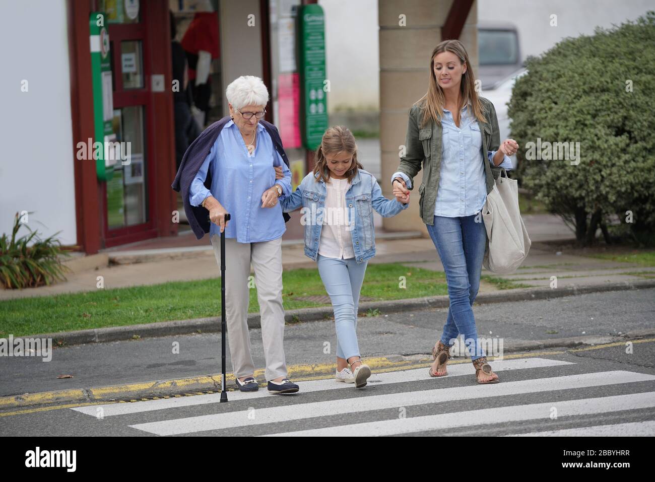 Grandmother, mother and daughter crossing the street Stock Photo - Alamy