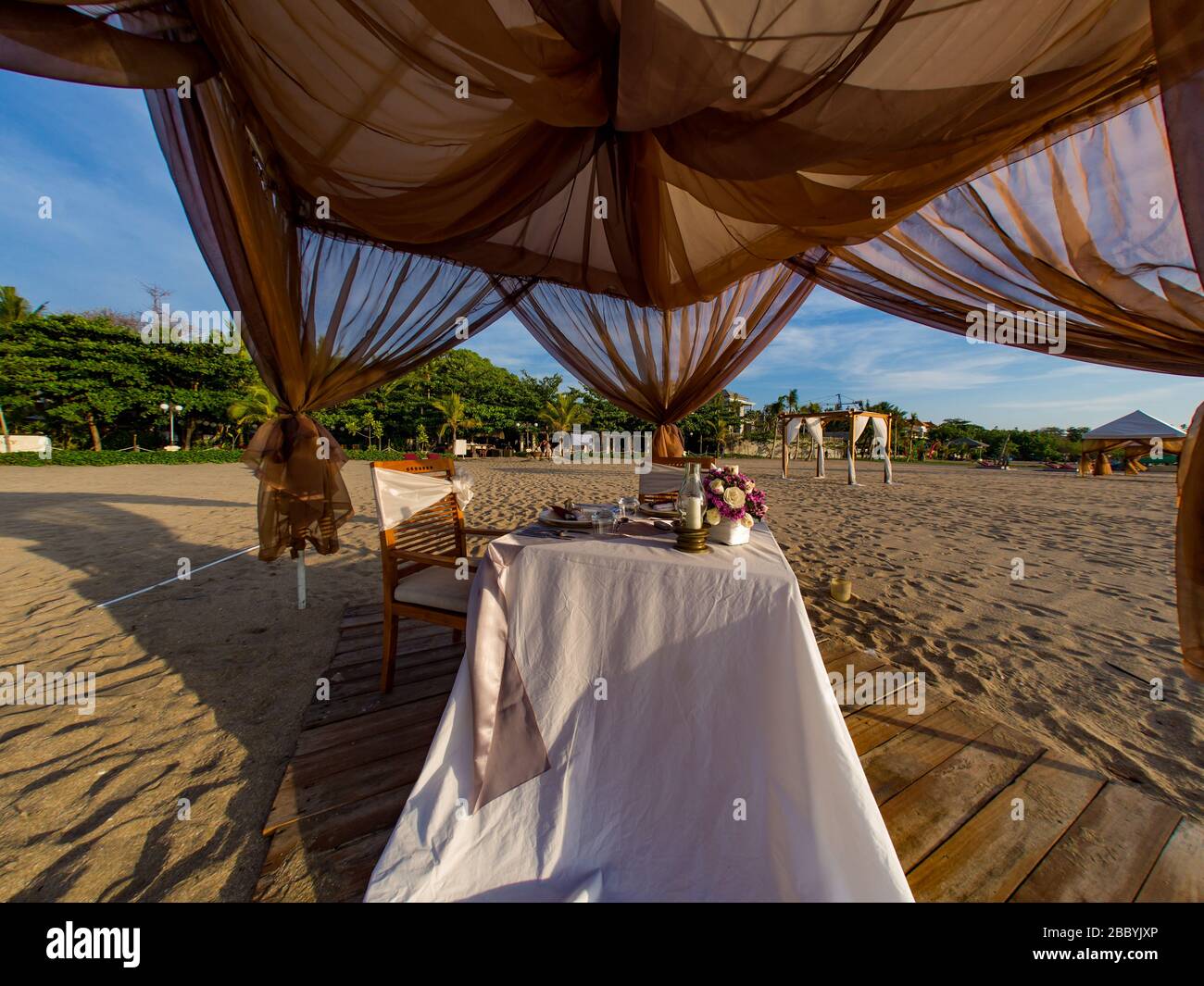 Dinner table at the beach at sunset in Bali Stock Photo - Alamy