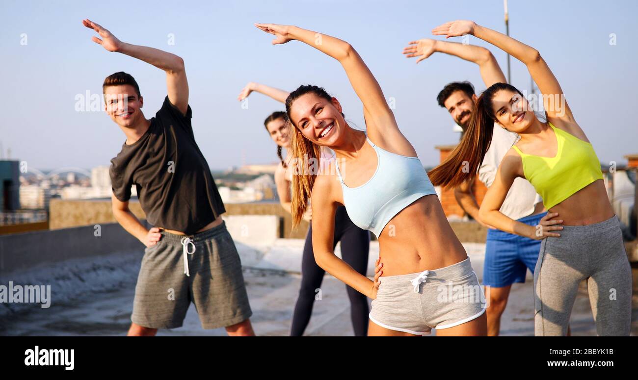 Portrait of smiling fit happy people doing power fitness exercise Stock ...