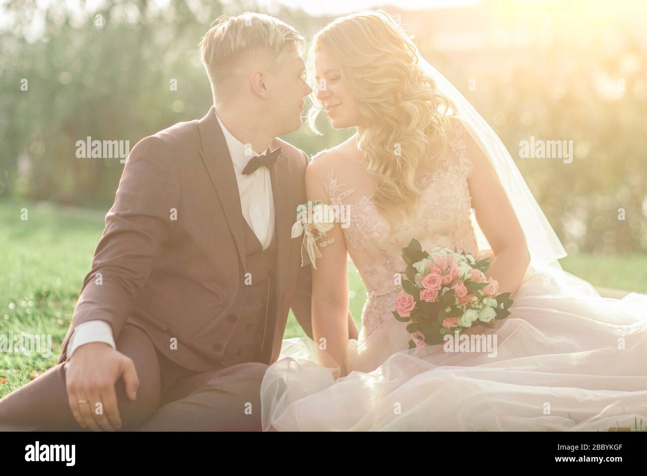 portrait of bride and groom looking at each other Stock Photo - Alamy