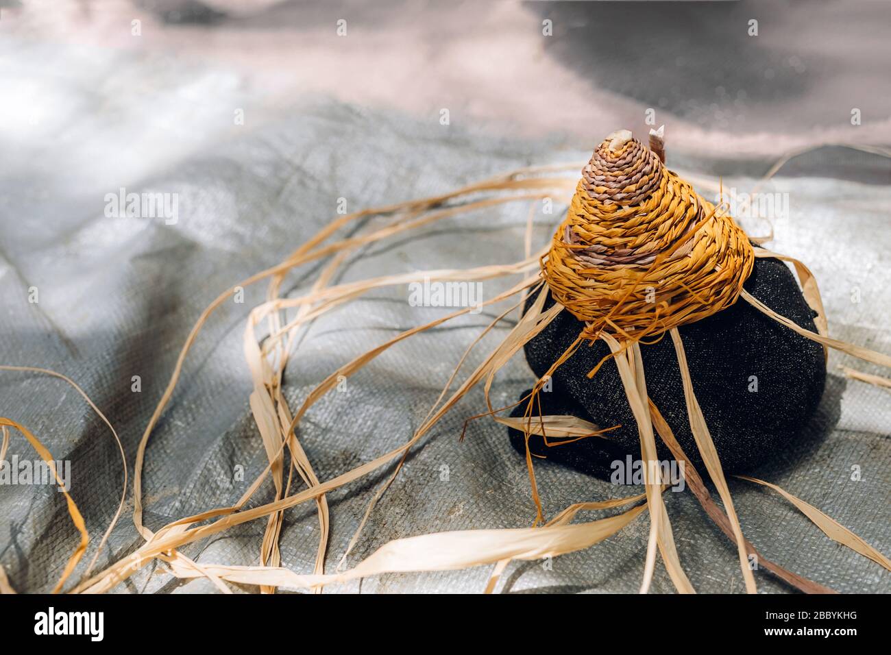 Handmade weaving basket in process of making. Craft workshop. Close up ...