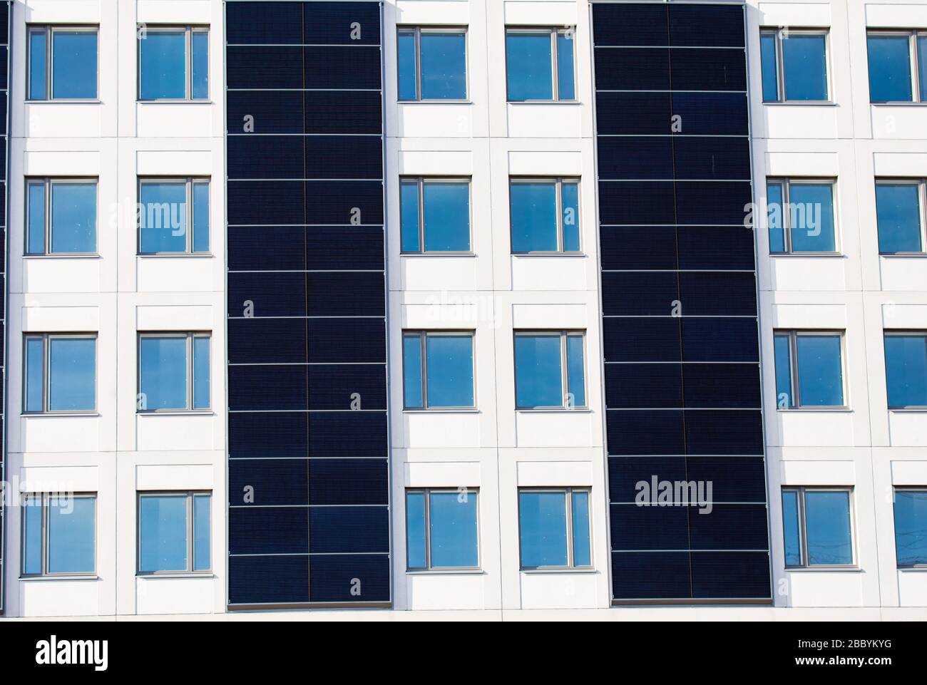 White building with Solar panels installed on the outer walls Stock ...