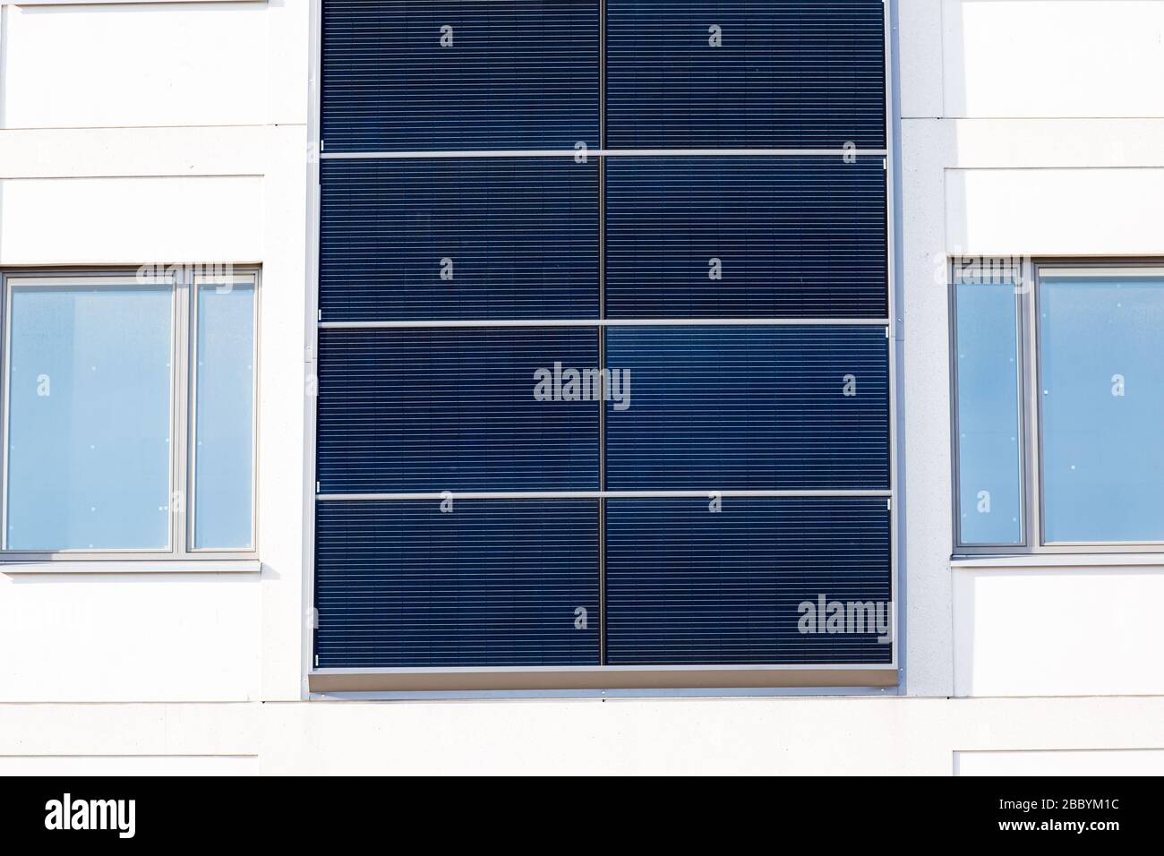 White building with Solar panels installed on the outer walls Stock ...