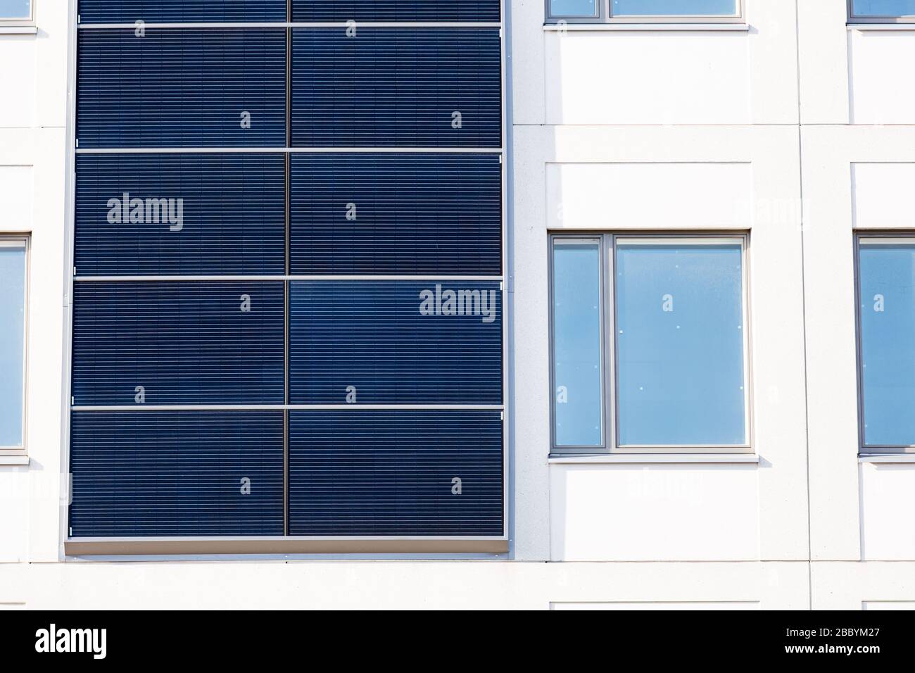 White building with Solar panels installed on the outer walls Stock ...