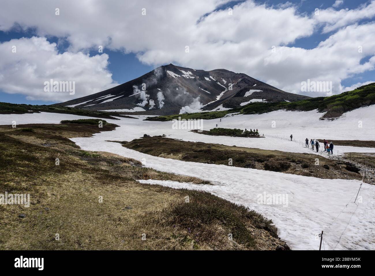 View of Asahidake (Mount Asahi) in Japan, taken in June. Snow is still ...