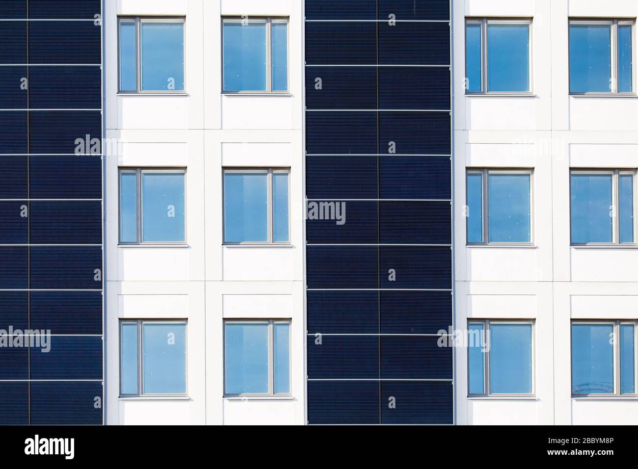 White building with Solar panels installed on the outer walls Stock ...