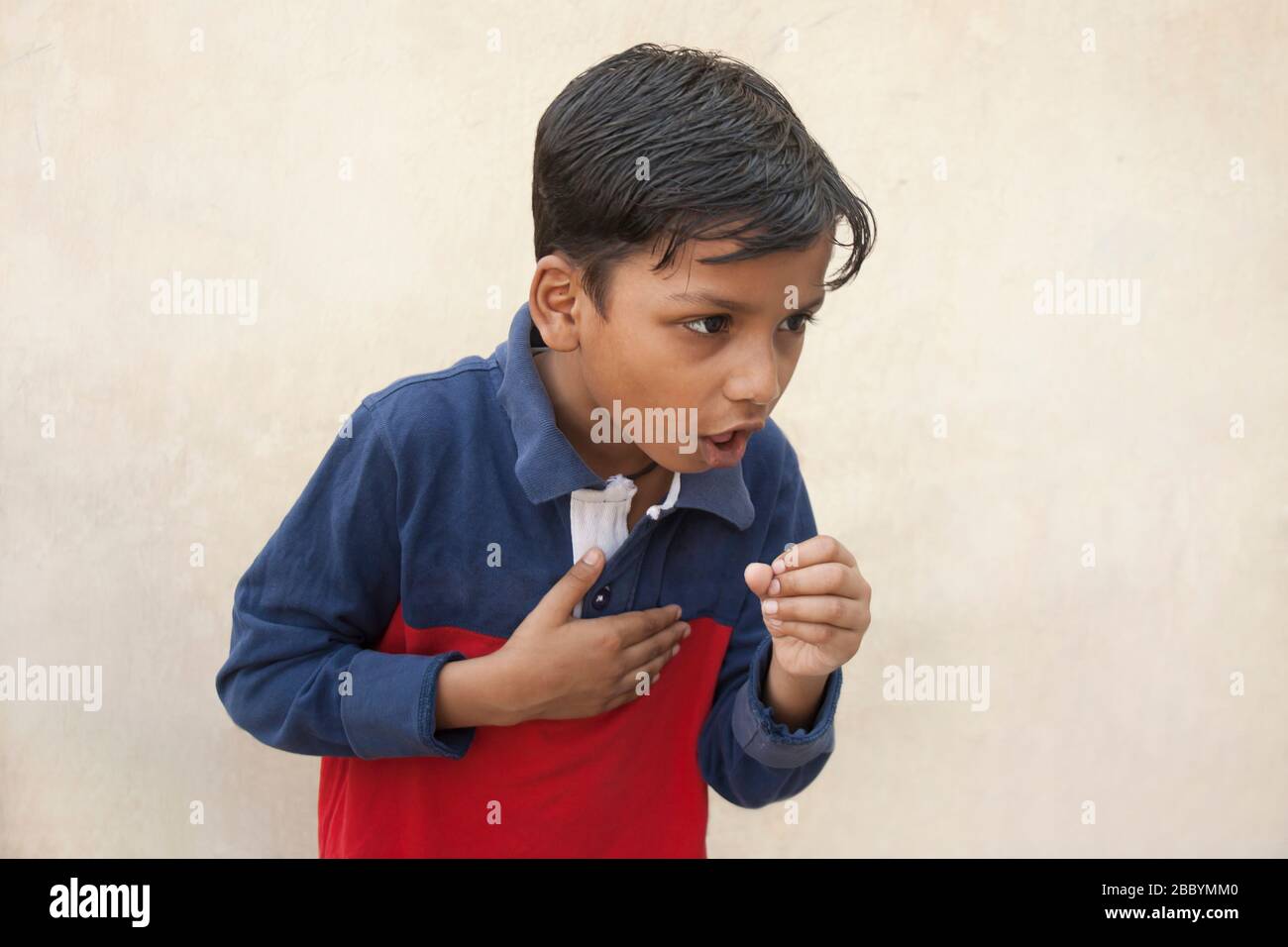 Boy covered mouth with hand, cough, keeping hand on chest Stock Photo ...