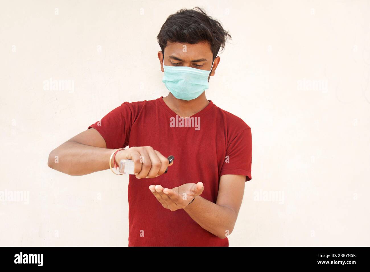 A Boy clean their hands with hand sanitize Stock Photo - Alamy