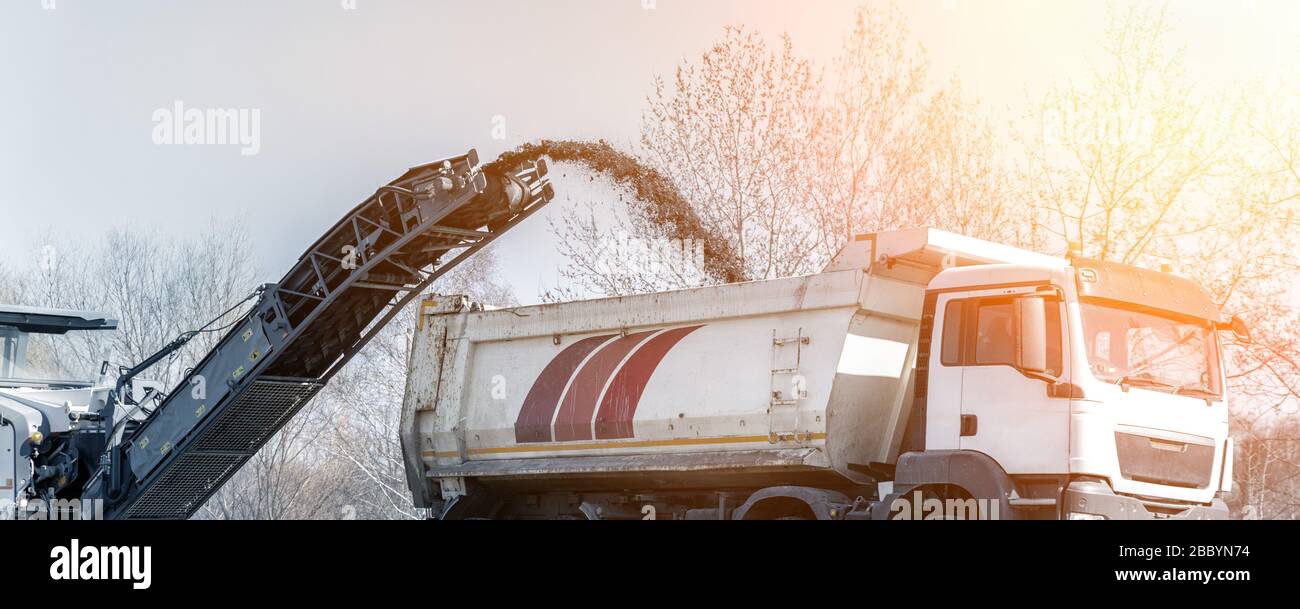 Asphalt milling and grinding machine at road repair and construction ...