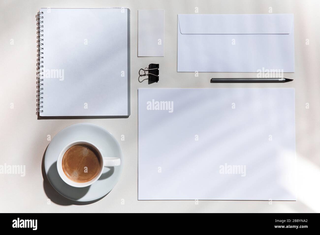 Sheets, coffee, work tools on a white table indoors. Creative, cozy ...