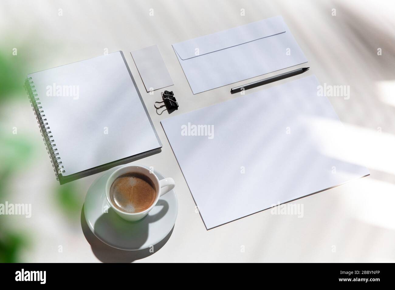Sheets, coffee, work tools on a white table indoors. Creative, cozy ...