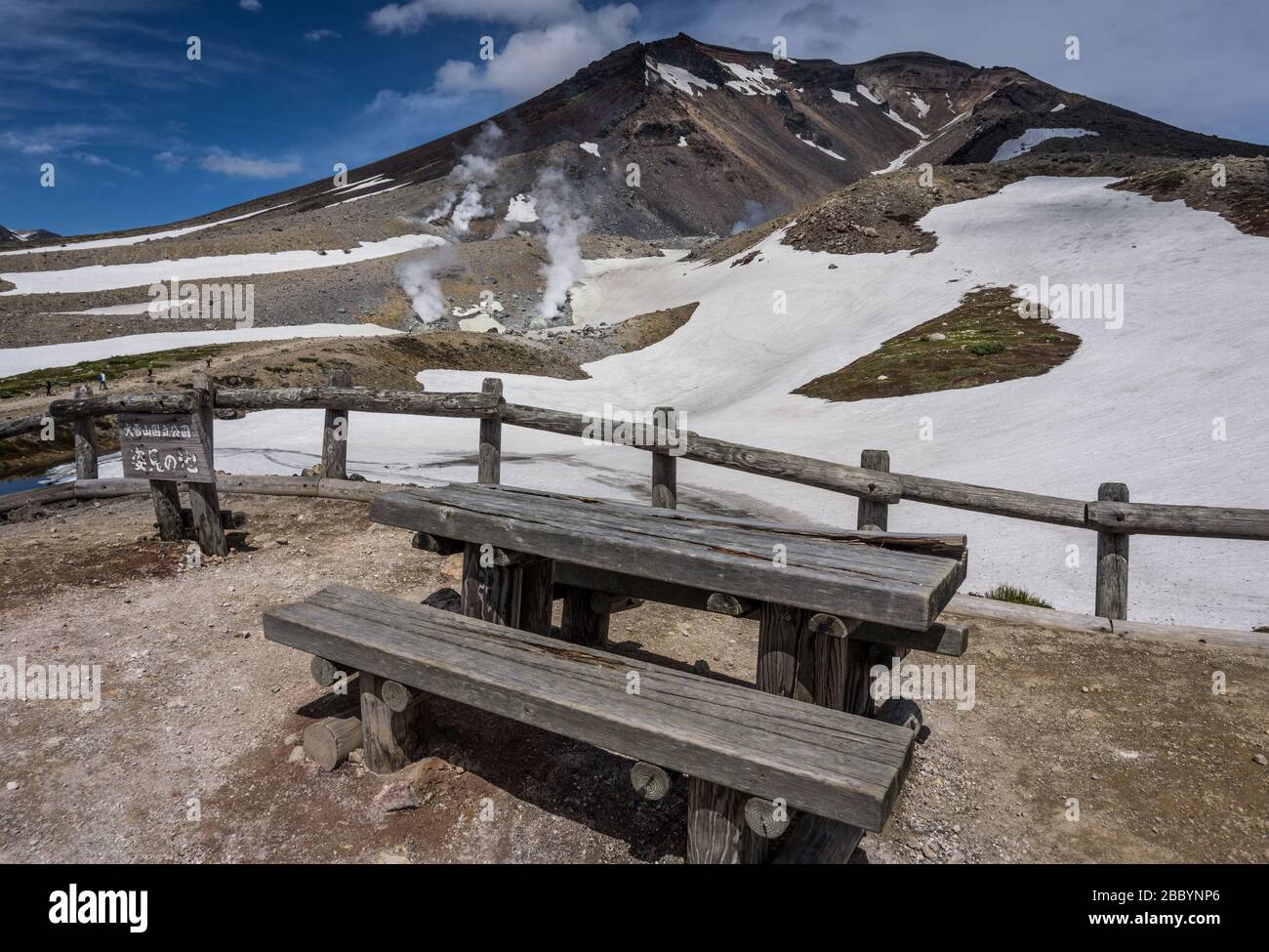 View of Asahidake (Mount Asahi) in Japan, taken in June. Snow is still ...