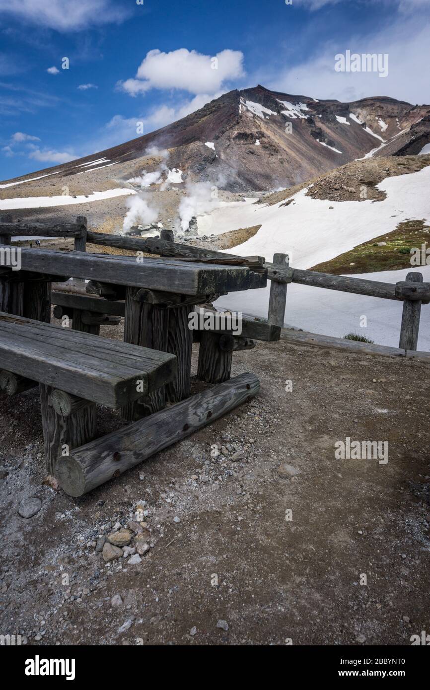 View of Asahidake (Mount Asahi) in Japan, taken in June. Snow is still ...
