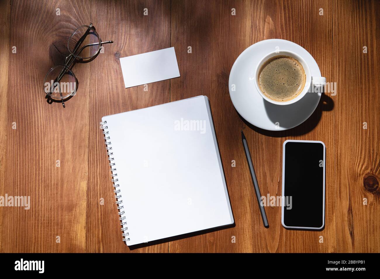 Gadgets, coffee, work tools on a wooden table indoors. Creative, cozy ...