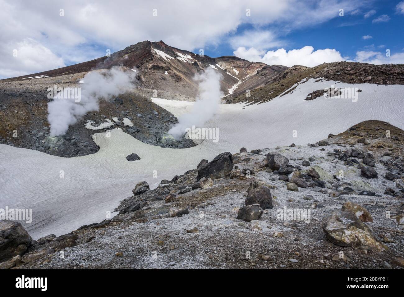 View of Asahidake (Mount Asahi) in Japan, taken in June. Snow is still ...