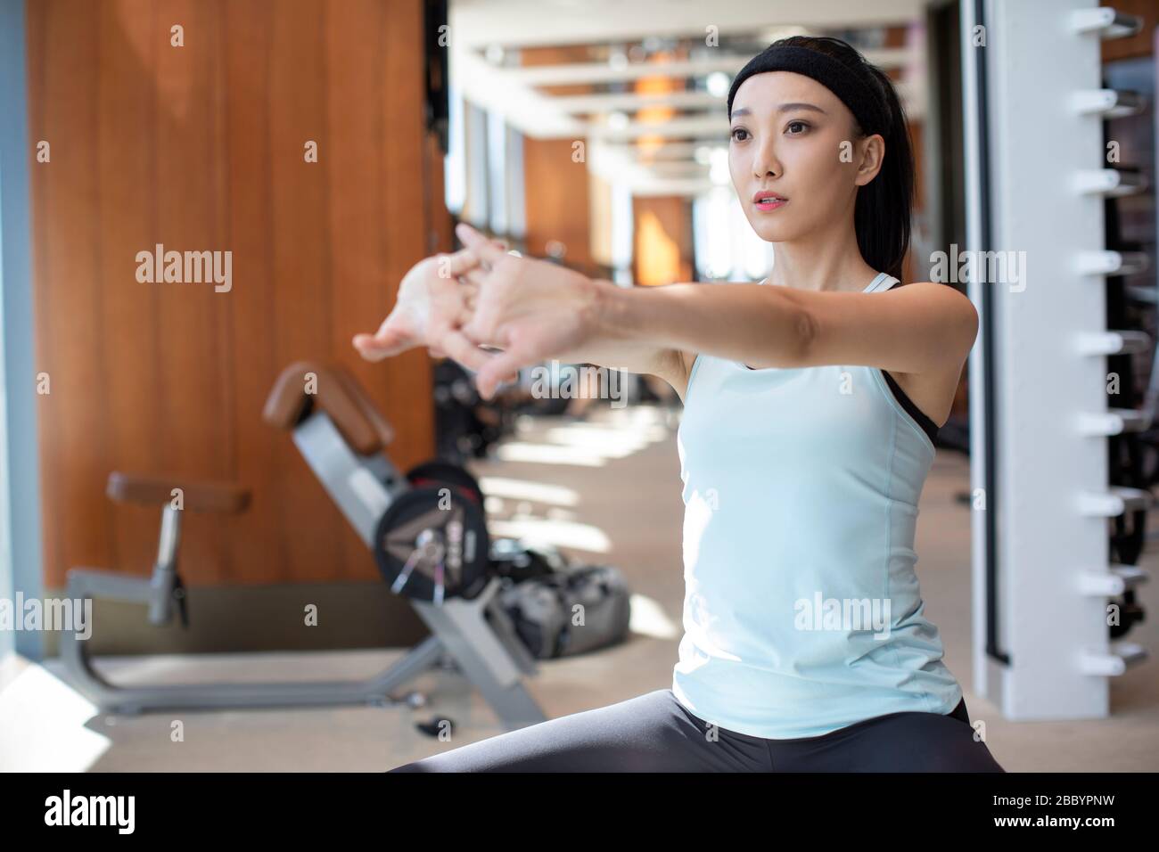 Young Chinese woman exercising at gym Stock Photo - Alamy